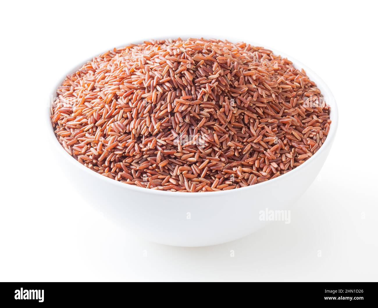 Uncooked red rice in white bowl isolated on white background with ...