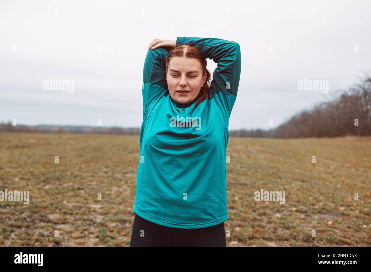 Chubby caucasian woman doing morning stretching exercises. Healthy ...