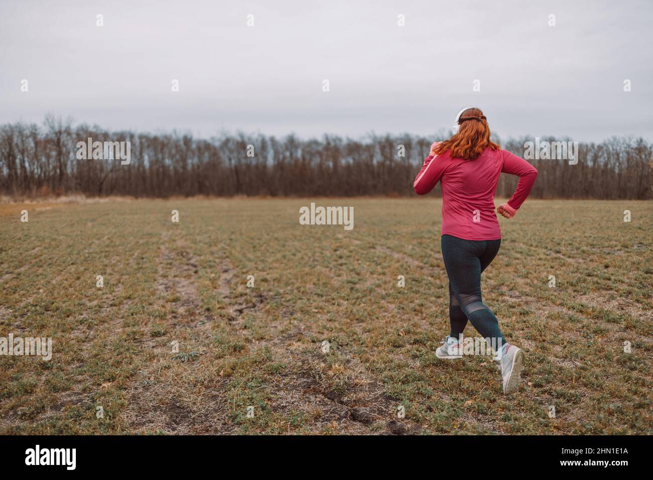 Overweight runner caucasian woman jogging in autumn park. Healthy ...