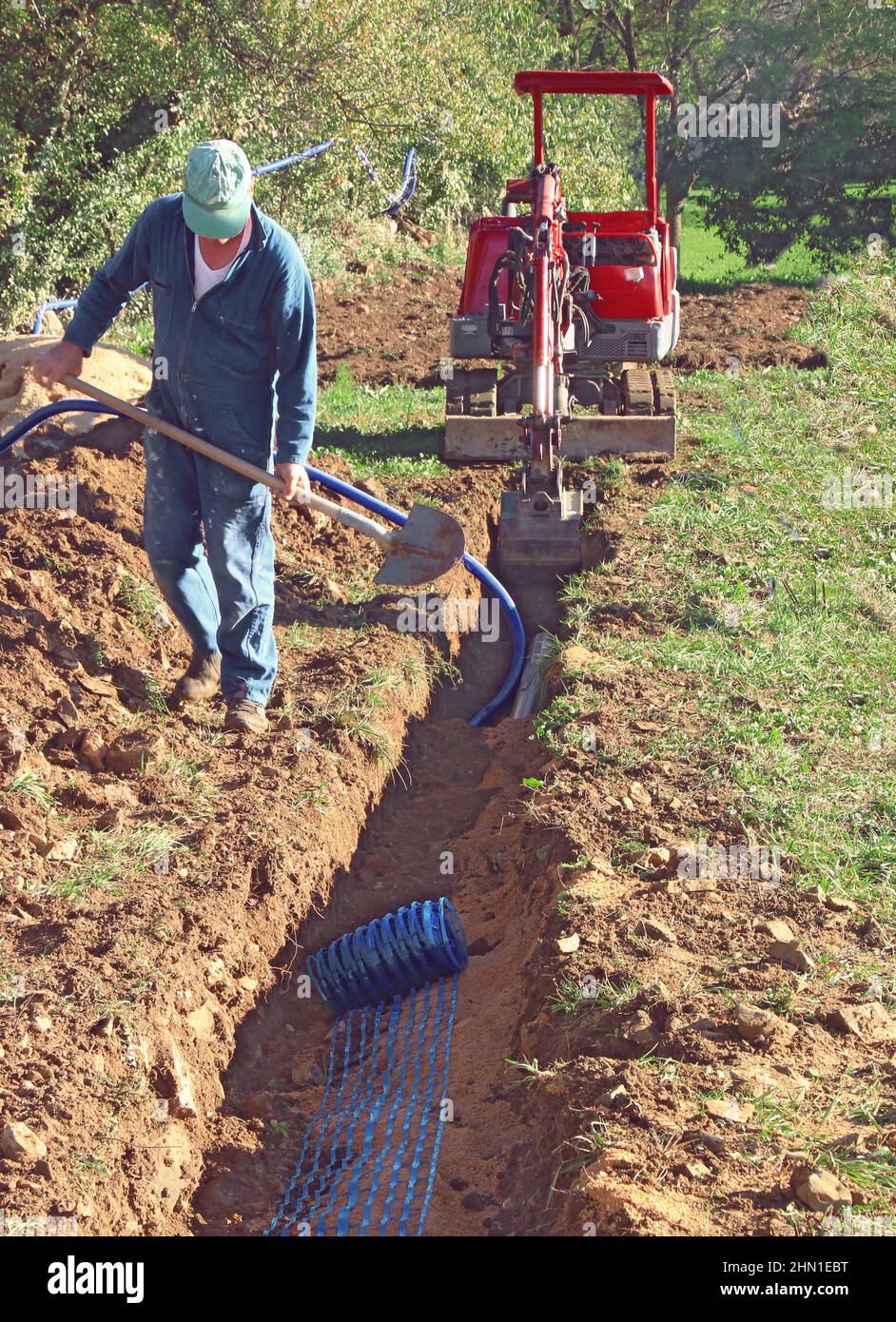 Laying pipes in the connecting trench of a house Stock Photo - Alamy