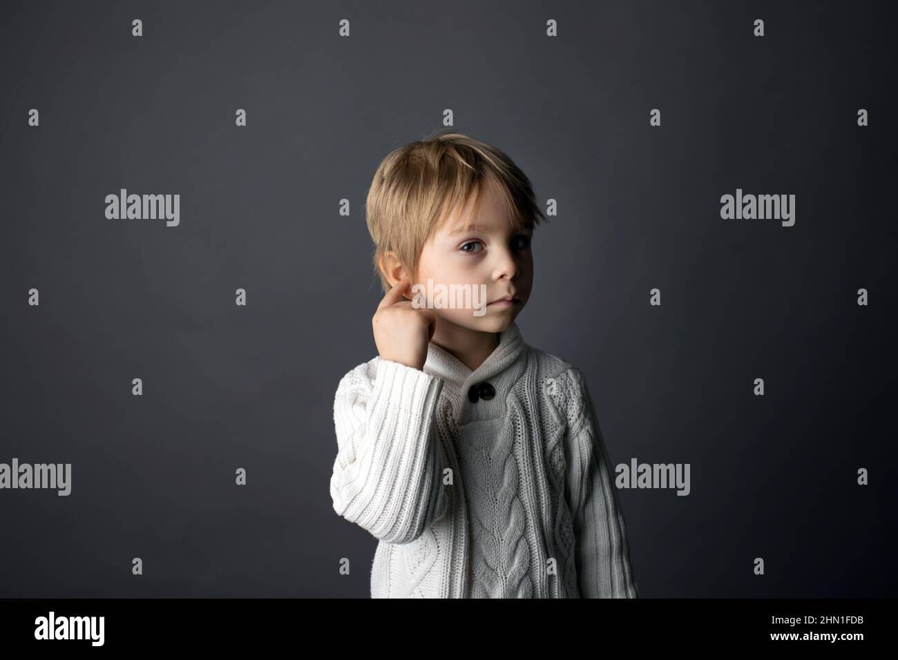 Cute little toddler boy, showing not hearing gesture in sign language ...