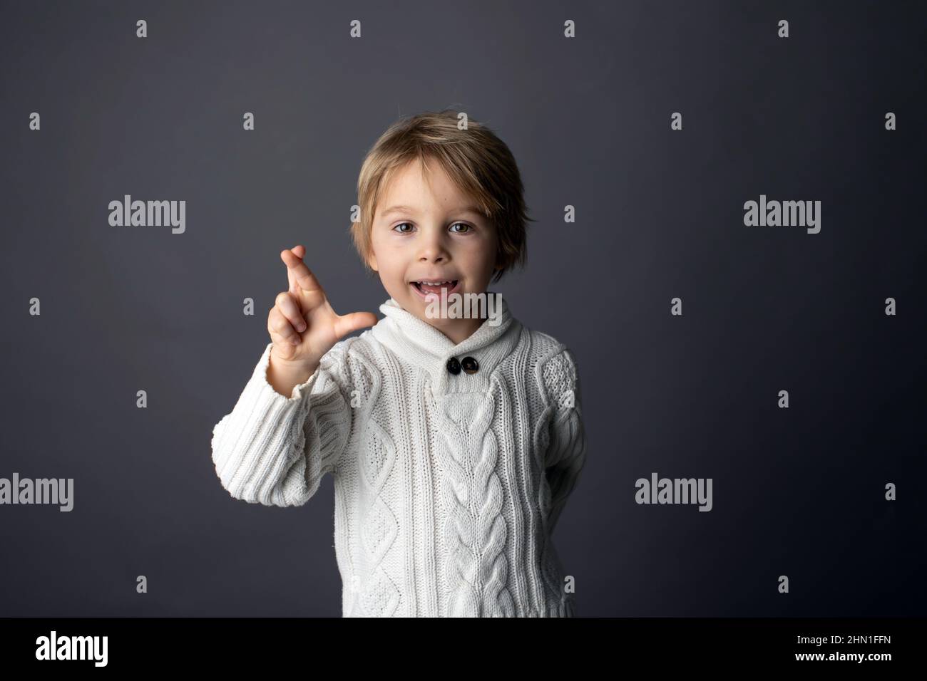 Cute little toddler boy, showing WISH FOR LUCK gesture in sign language ...
