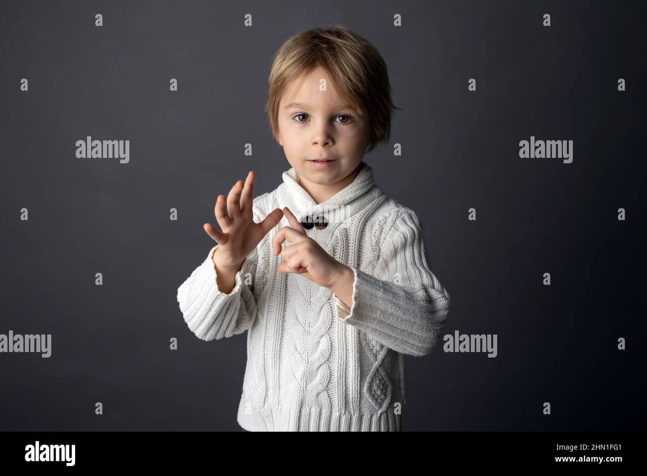 Cute little toddler boy, showing gesturfor deaf people Stock Photo - Alamy