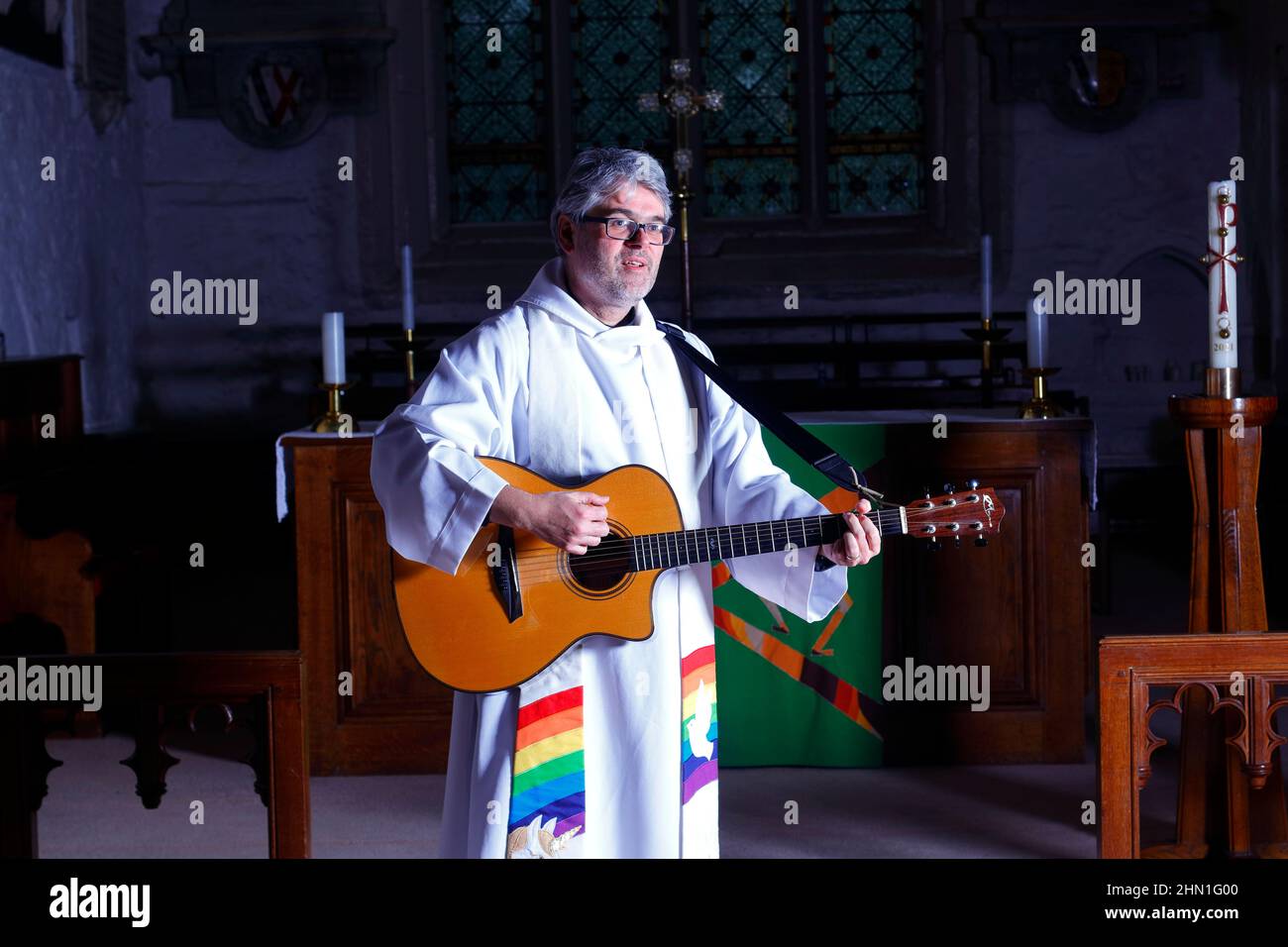 Reverend Bob Bailey playing guitar during one of his church services ...