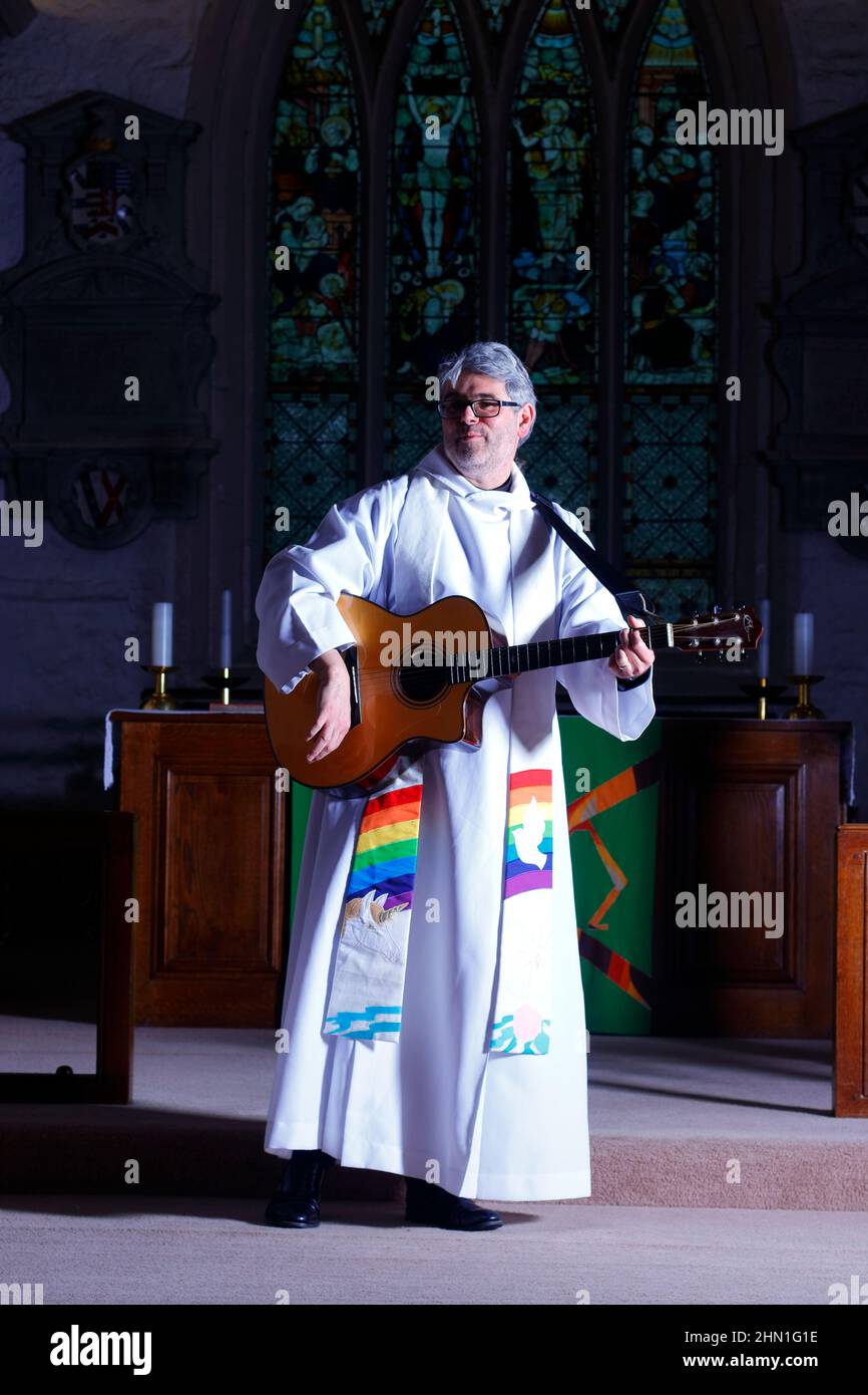 Reverend Bob Bailey playing guitar during one of his church services ...