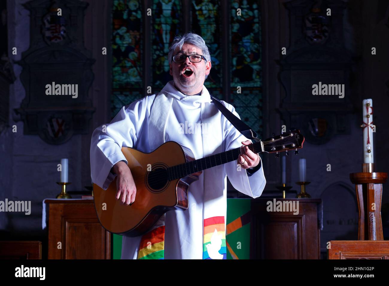 Reverend Bob Bailey playing guitar during one of his church services ...