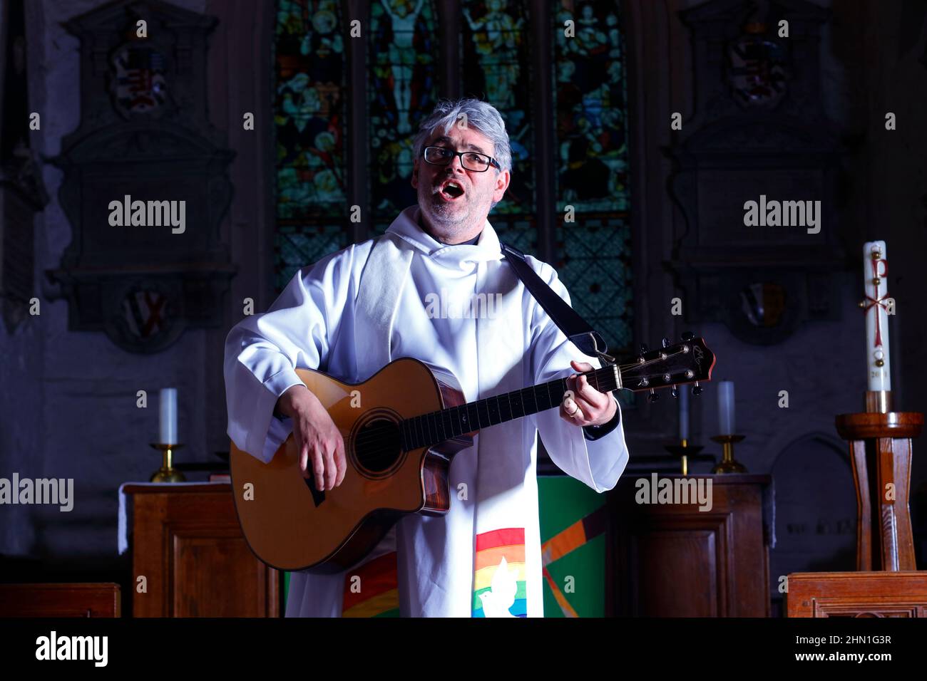 Reverend Bob Bailey playing guitar during one of his church services ...