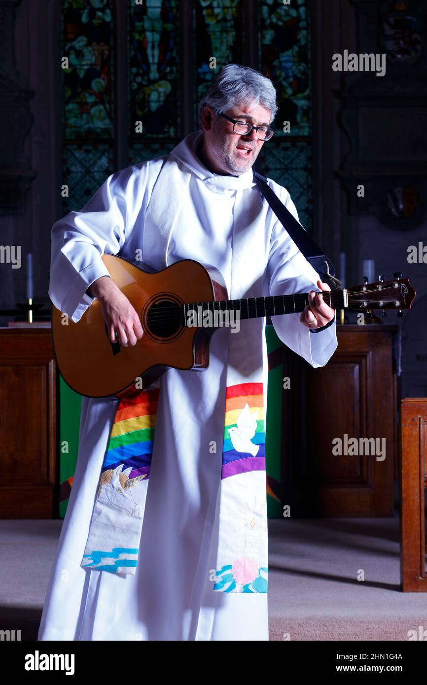 Reverend Bob Bailey playing guitar during one of his church services ...