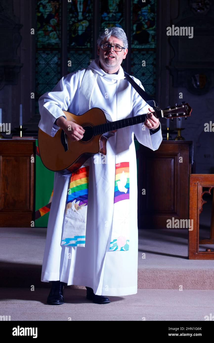 Reverend Bob Bailey playing guitar during one of his church services ...