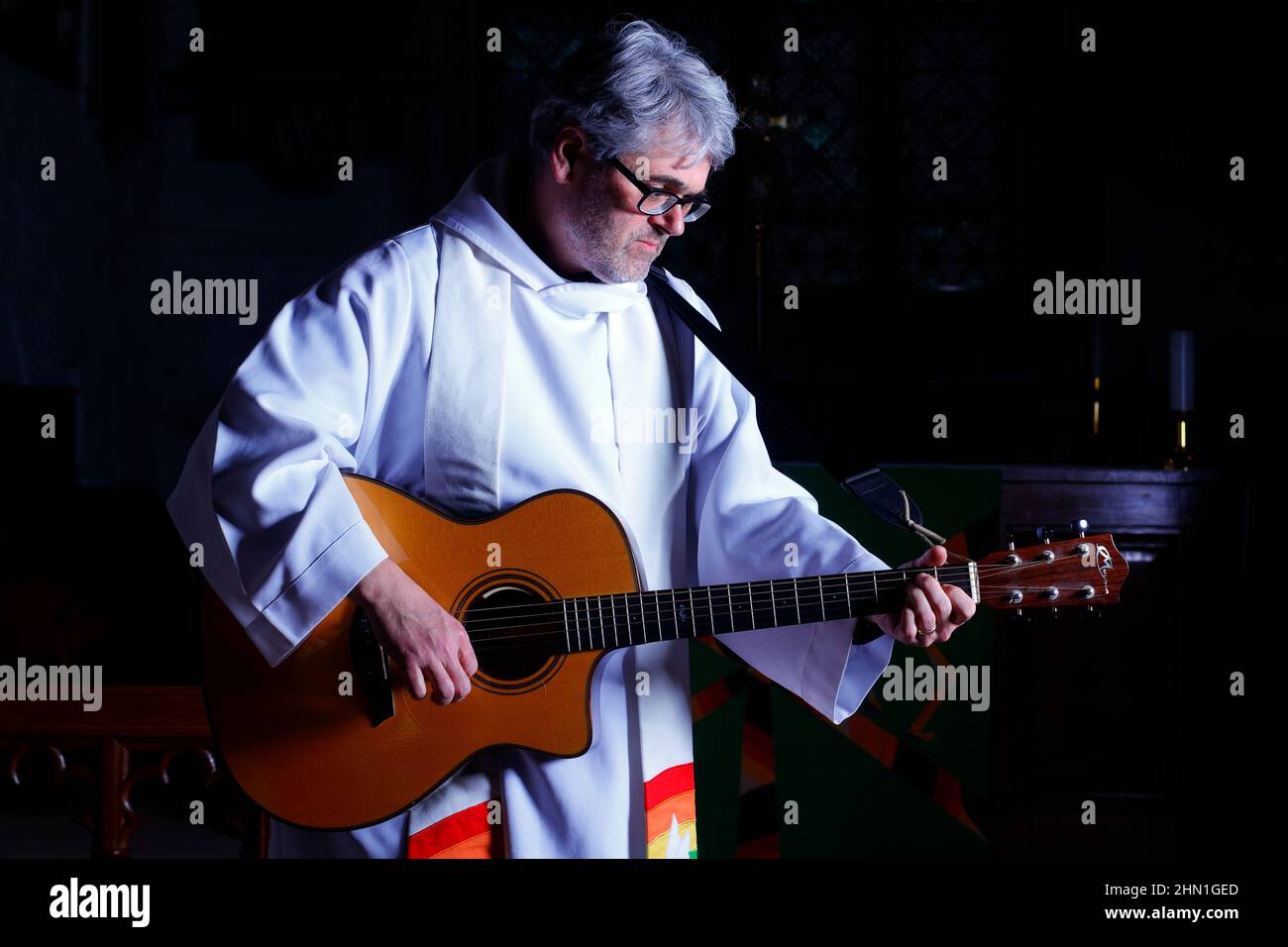 Reverend Bob Bailey playing guitar during one of his church services ...