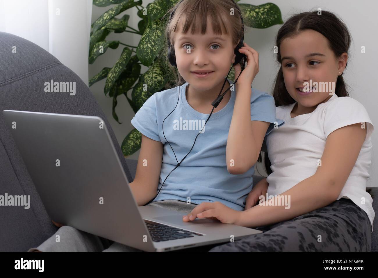 Distance learning online education. A school girls study at home and do ...