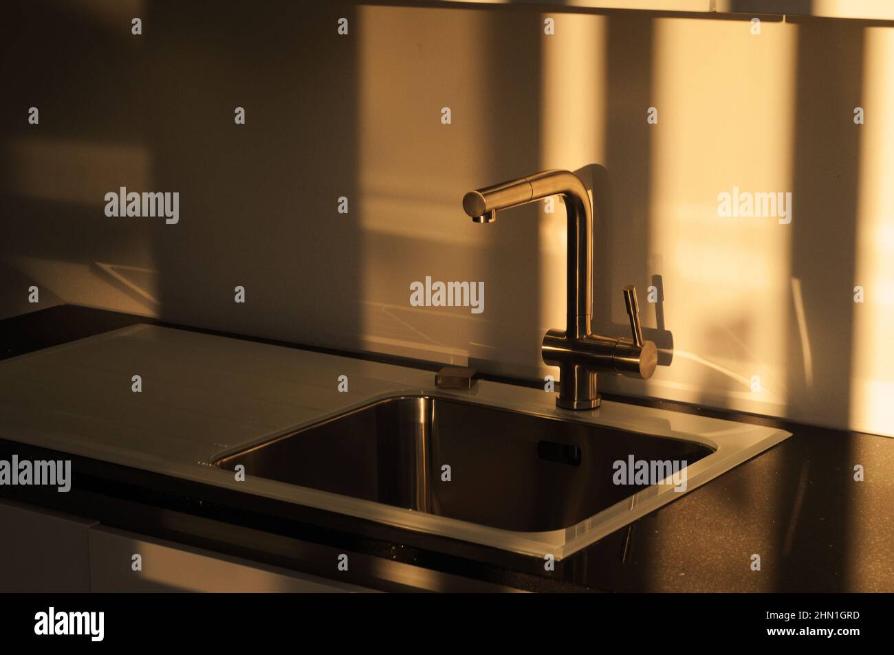 Modern kitchen in sunset, brand new interior design Stock Photo - Alamy