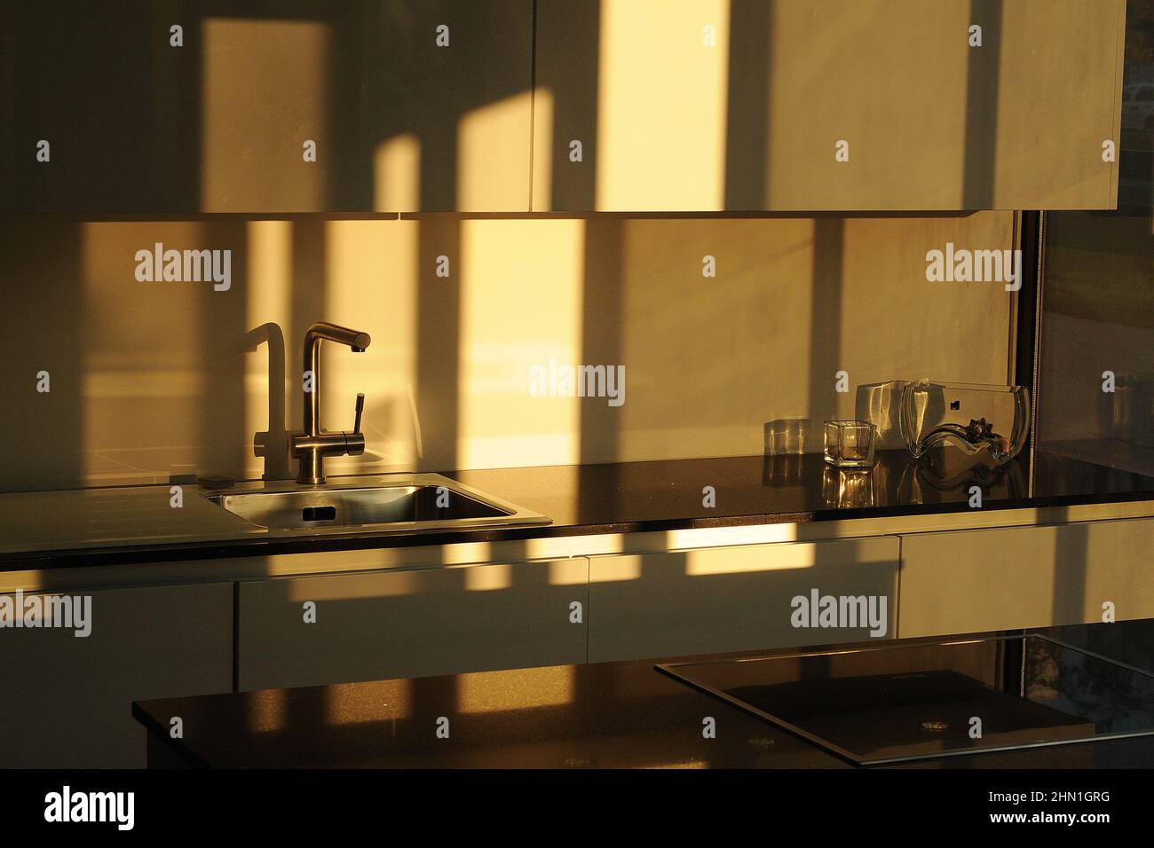 Modern kitchen in sunset, brand new interior design Stock Photo - Alamy