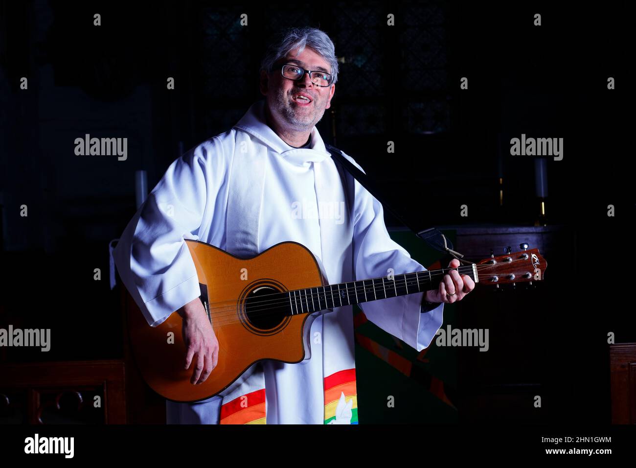 Reverend Bob Bailey playing guitar during one of his church services ...