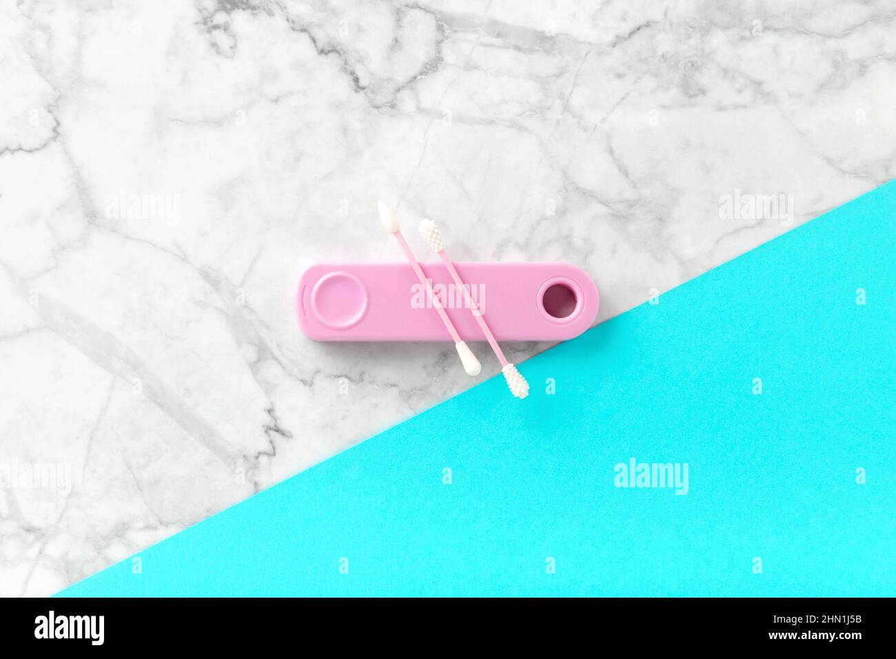 Flat lay top view reusable silicone swab on blue and marble background ...