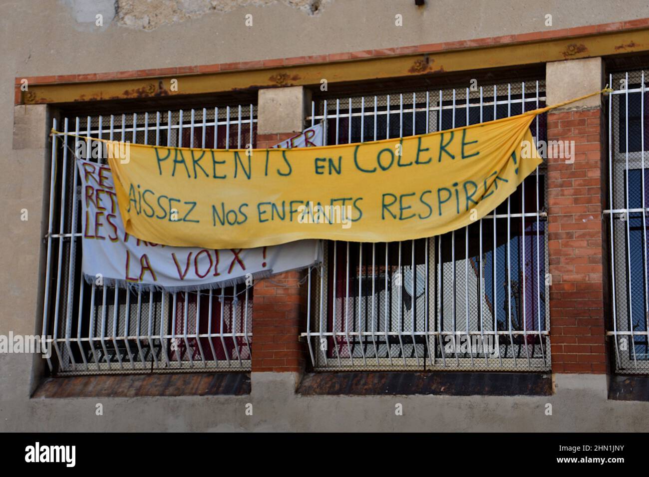 A banner against the compulsory wearing of facemasks in schools hangs ...
