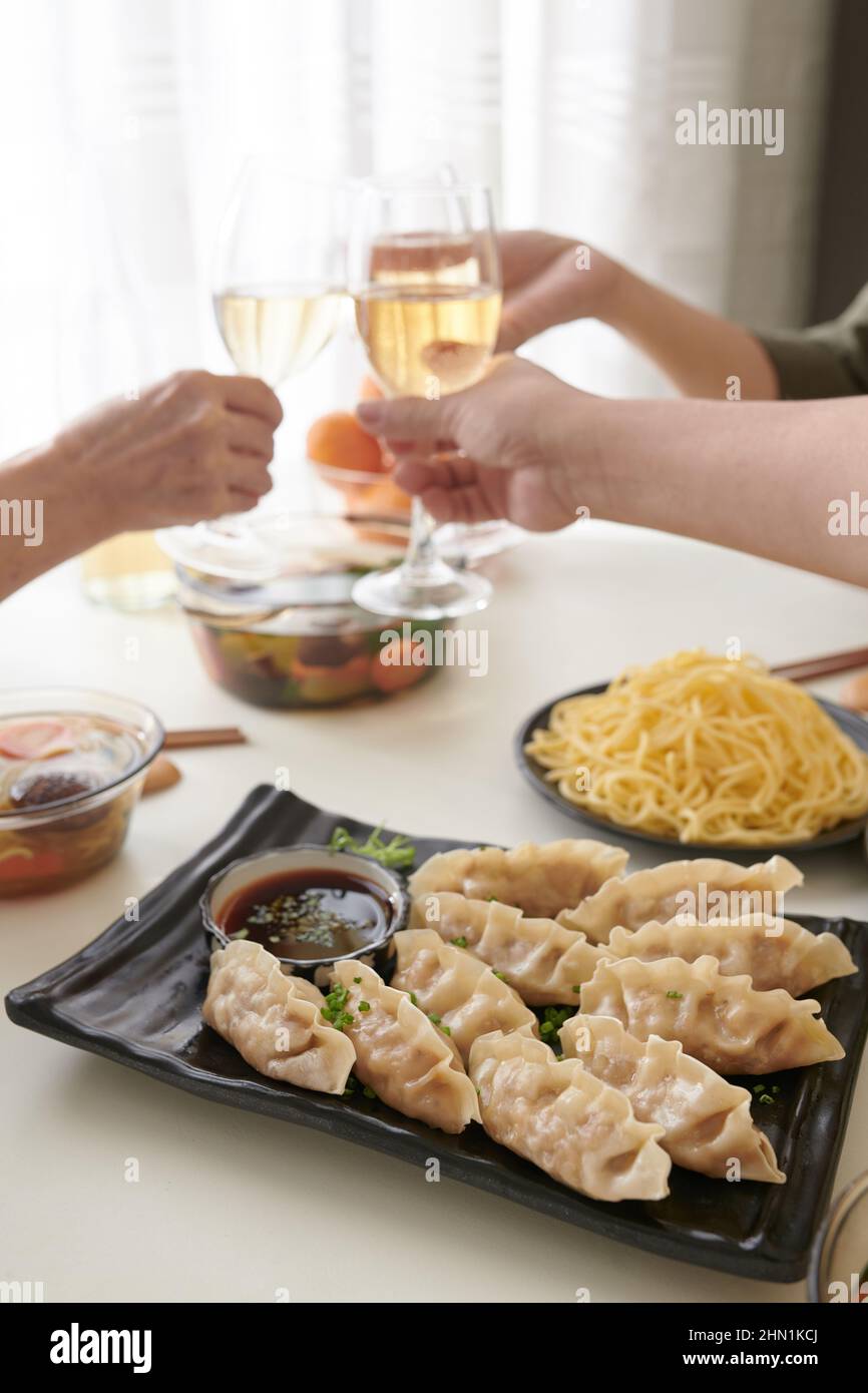 Plate with delicious homemade jiaozi and soy sauce on dinner table ...