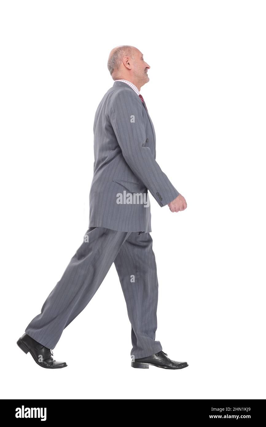 side view full length photo of a mid aged business man walking forward ...