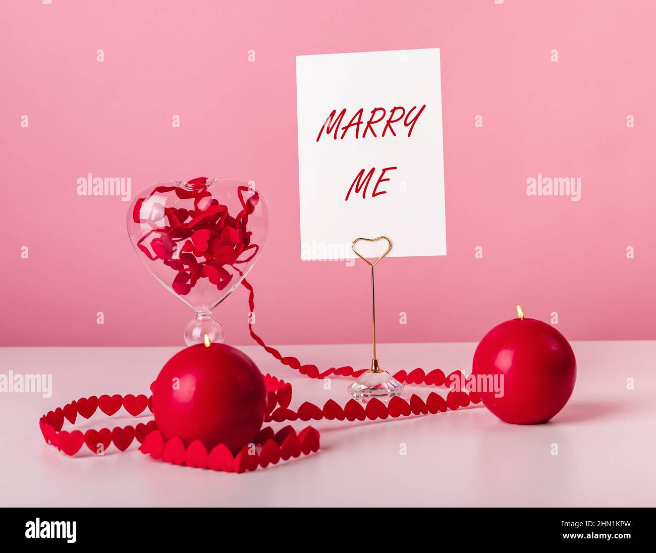 Marry me text on card for marriage proposal in red and pink colors ...