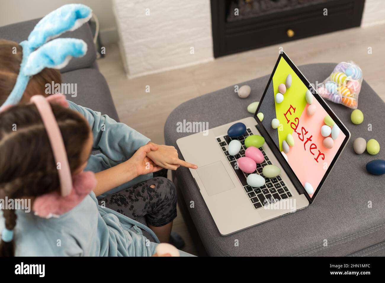 Cute little girls with bunny ears making a video call on a laptop Stock ...