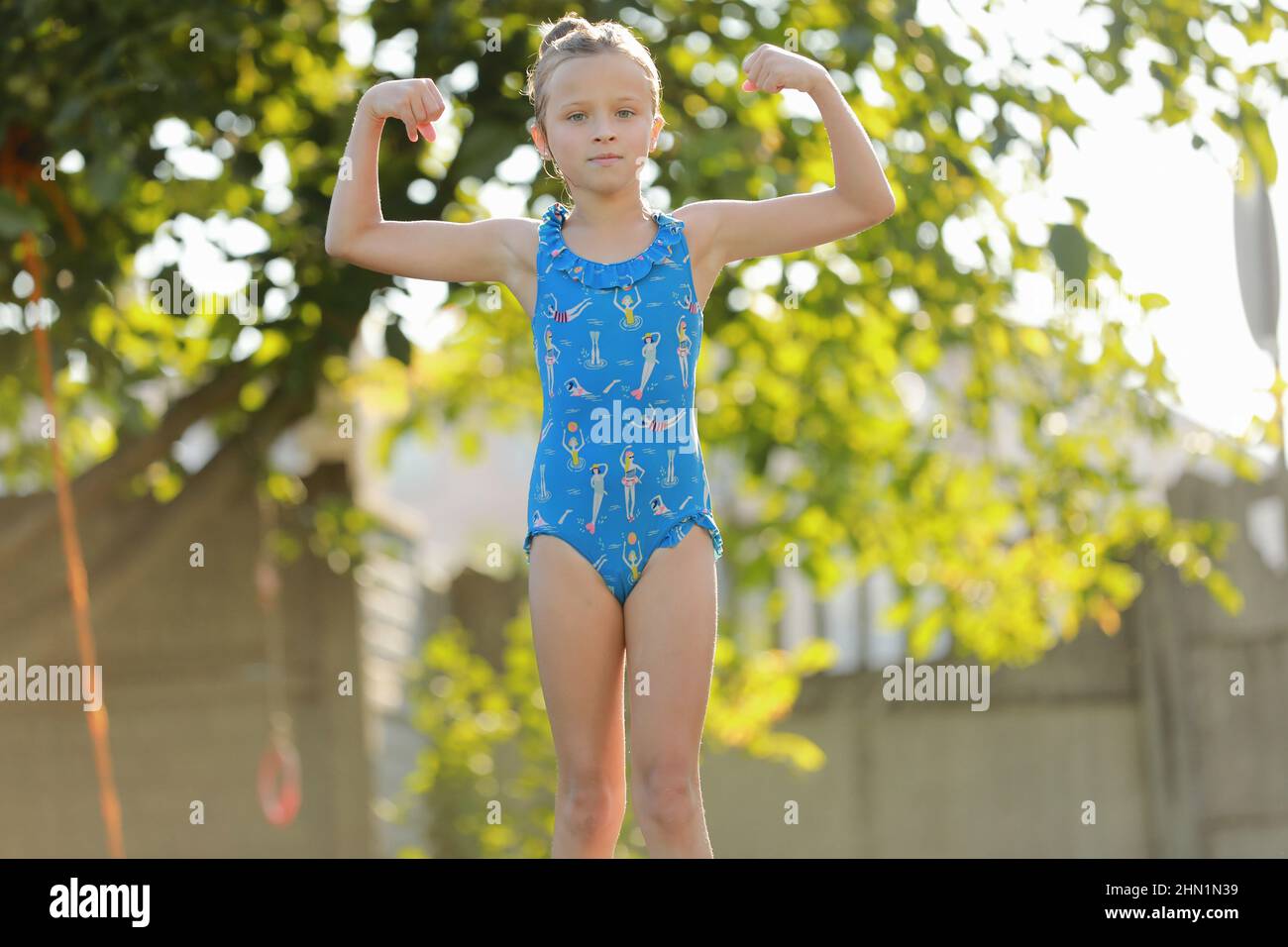 Happy strong kid girl showing hands bicep strength make fists feels ...