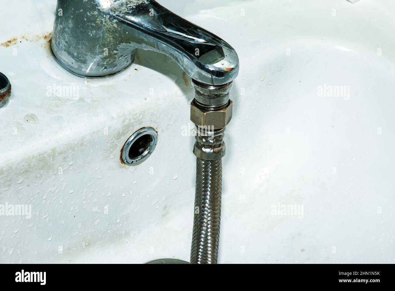 Water meter verification process. A flexible water hose is connected to ...