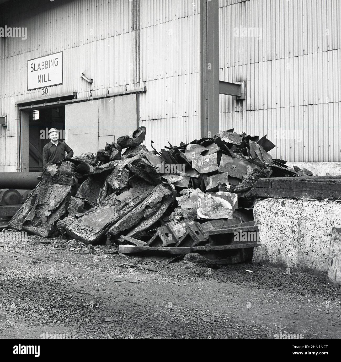 1950s, historical, steel worker standing outside a slabbing mill ...