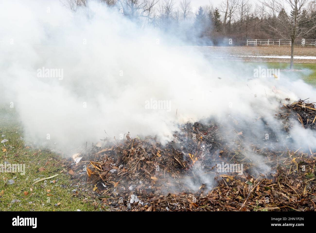 Thick smoke coming off a wildfire burning in a rural area causing ...