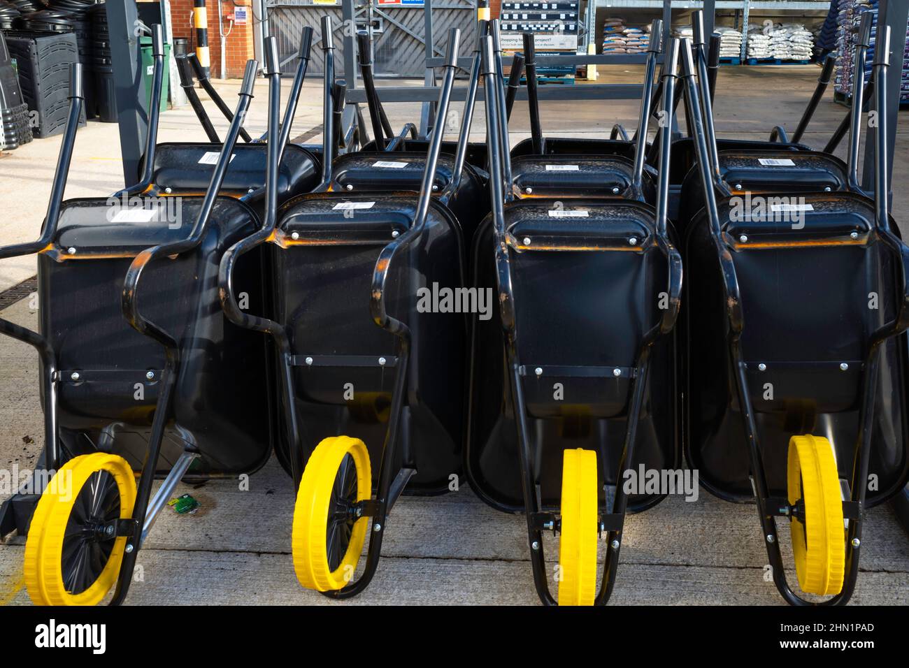 Traditional gardening tools black metal wheelbarrows with yellow ...