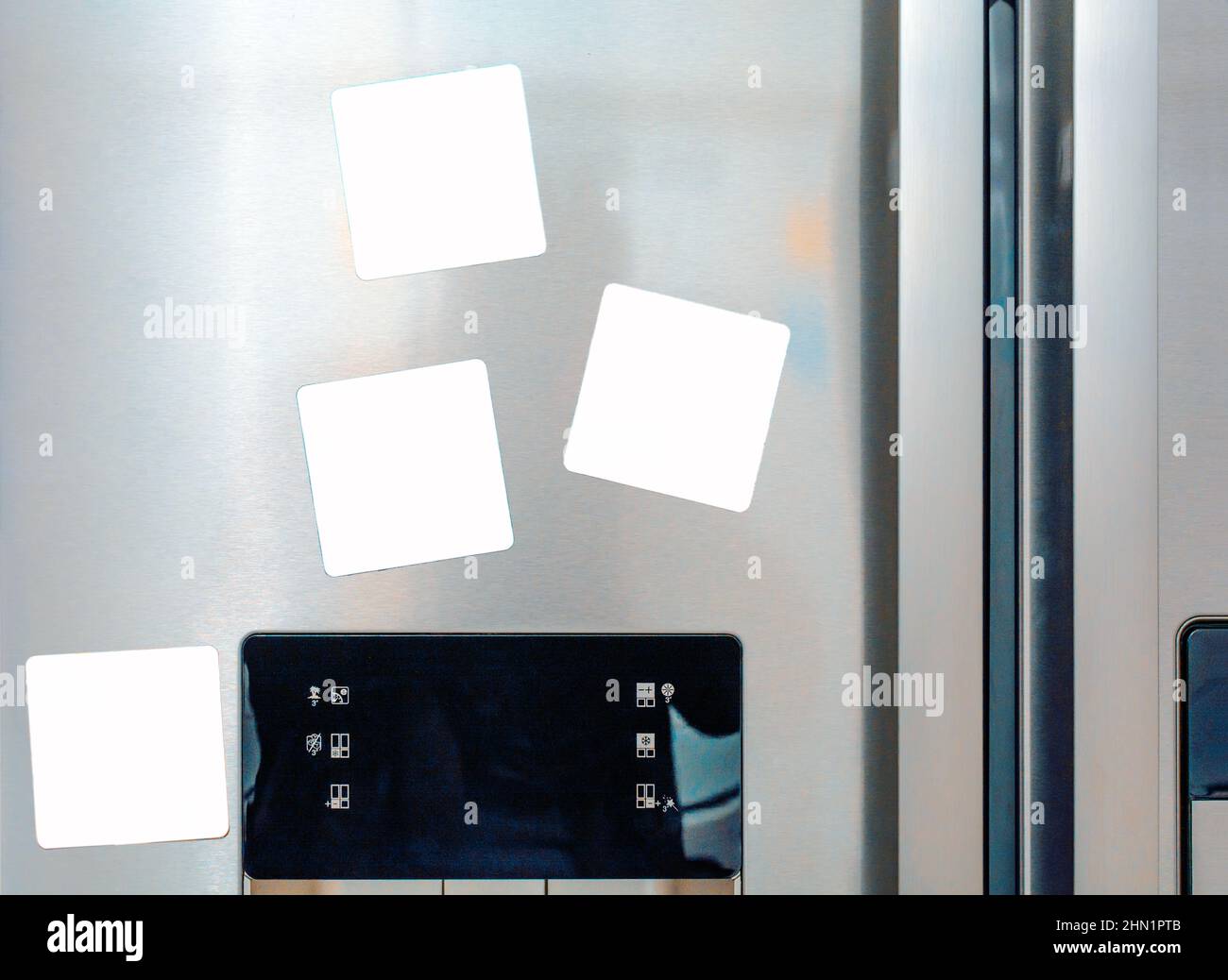 Four blank white paper notes attached on gray refrigerator door Stock ...