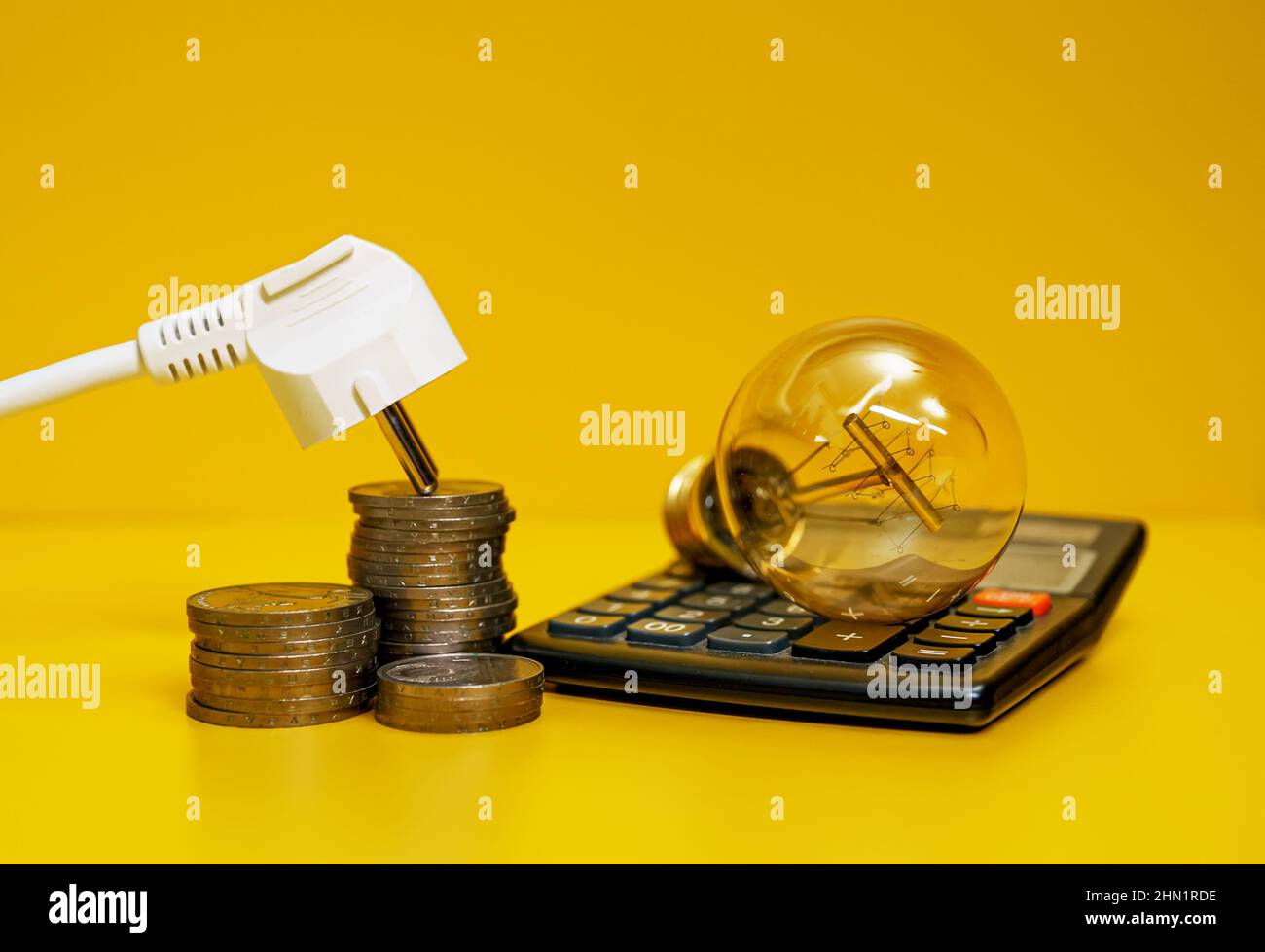Concept of rising electricity prices. Coins and calculator Stock Photo ...