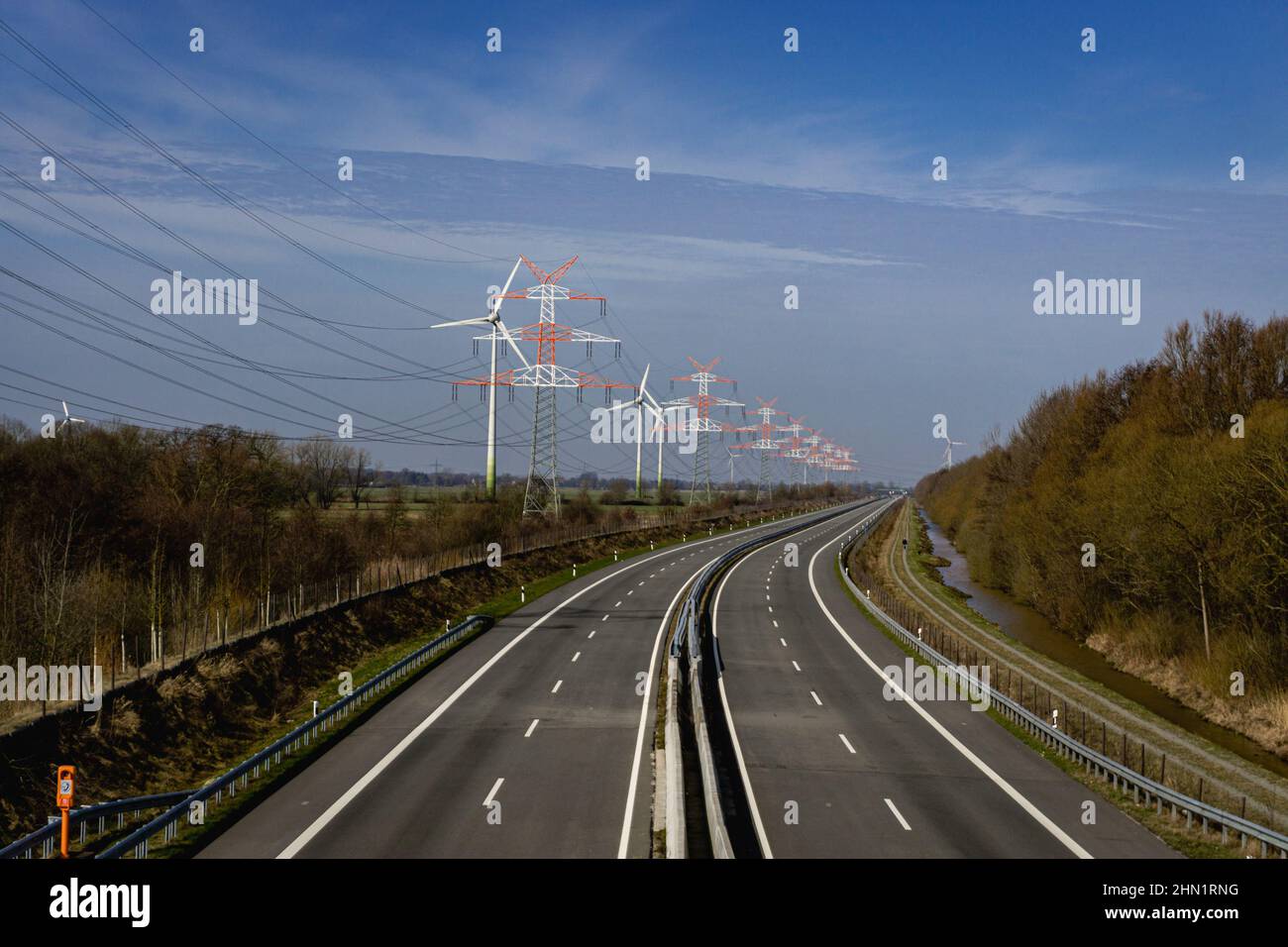 Empty road with transmission towers in the background Stock Photo - Alamy