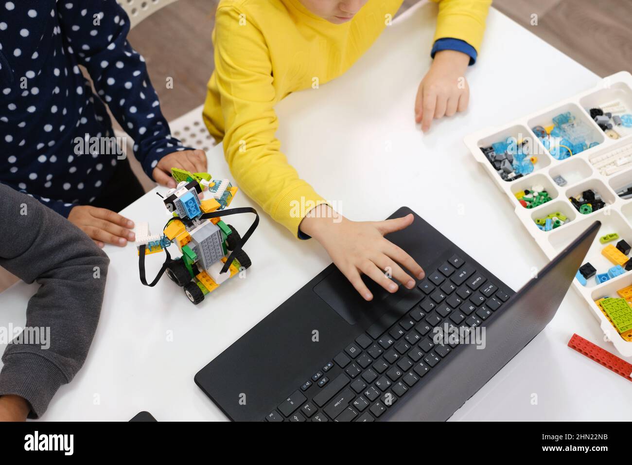 Kids learning coding, science and technology at school class. African ...