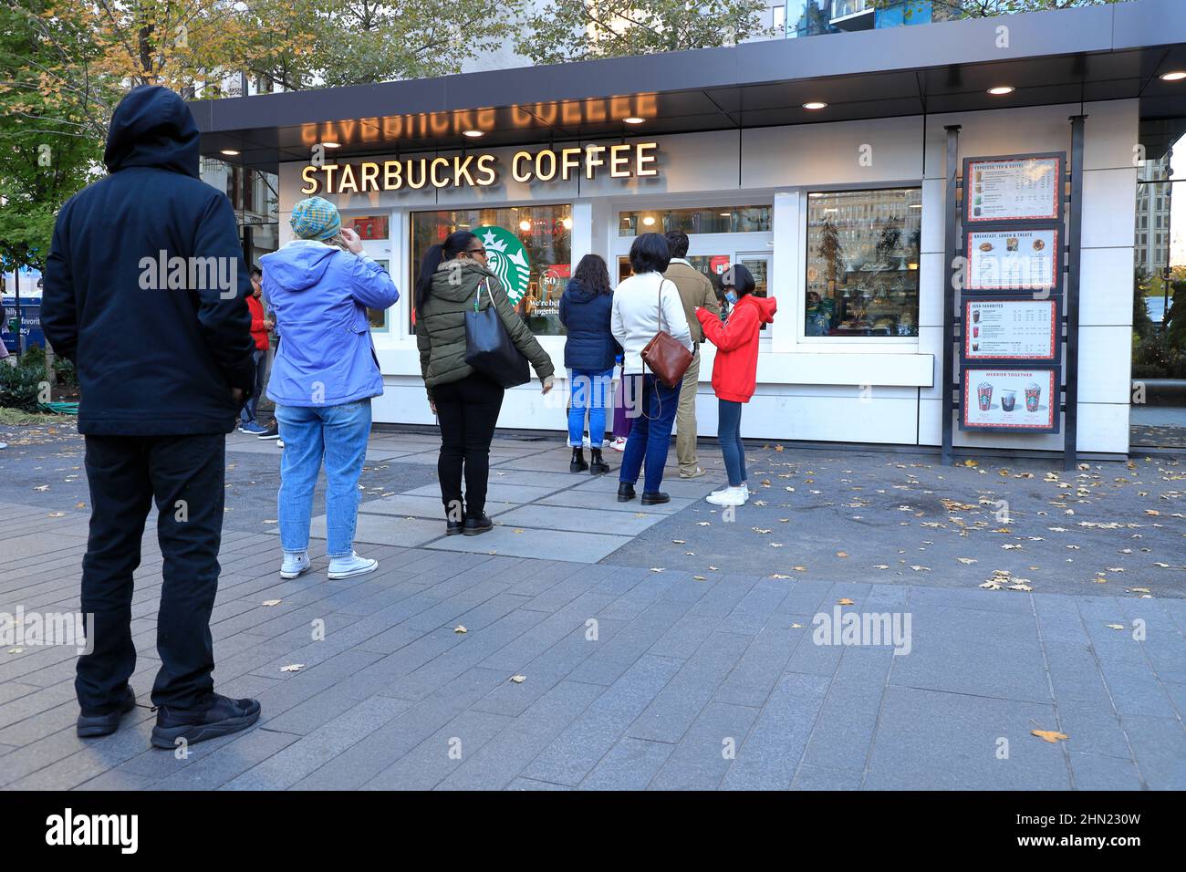 Customers waiting in line outside of a Starbucks Coffee in Dilworth ...