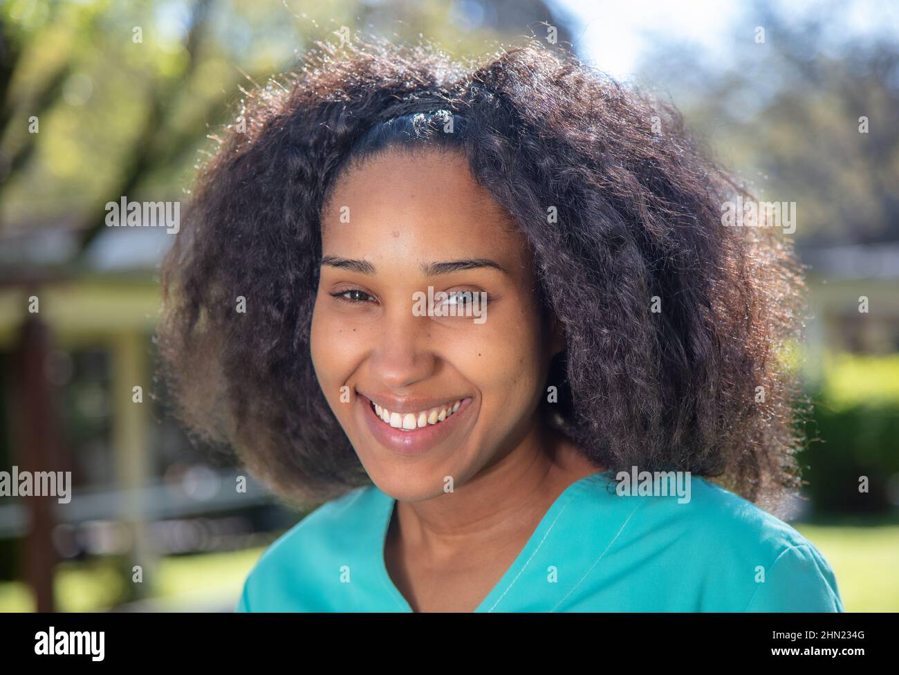 Confident female african doctor smiling outdoor Stock Photo - Alamy