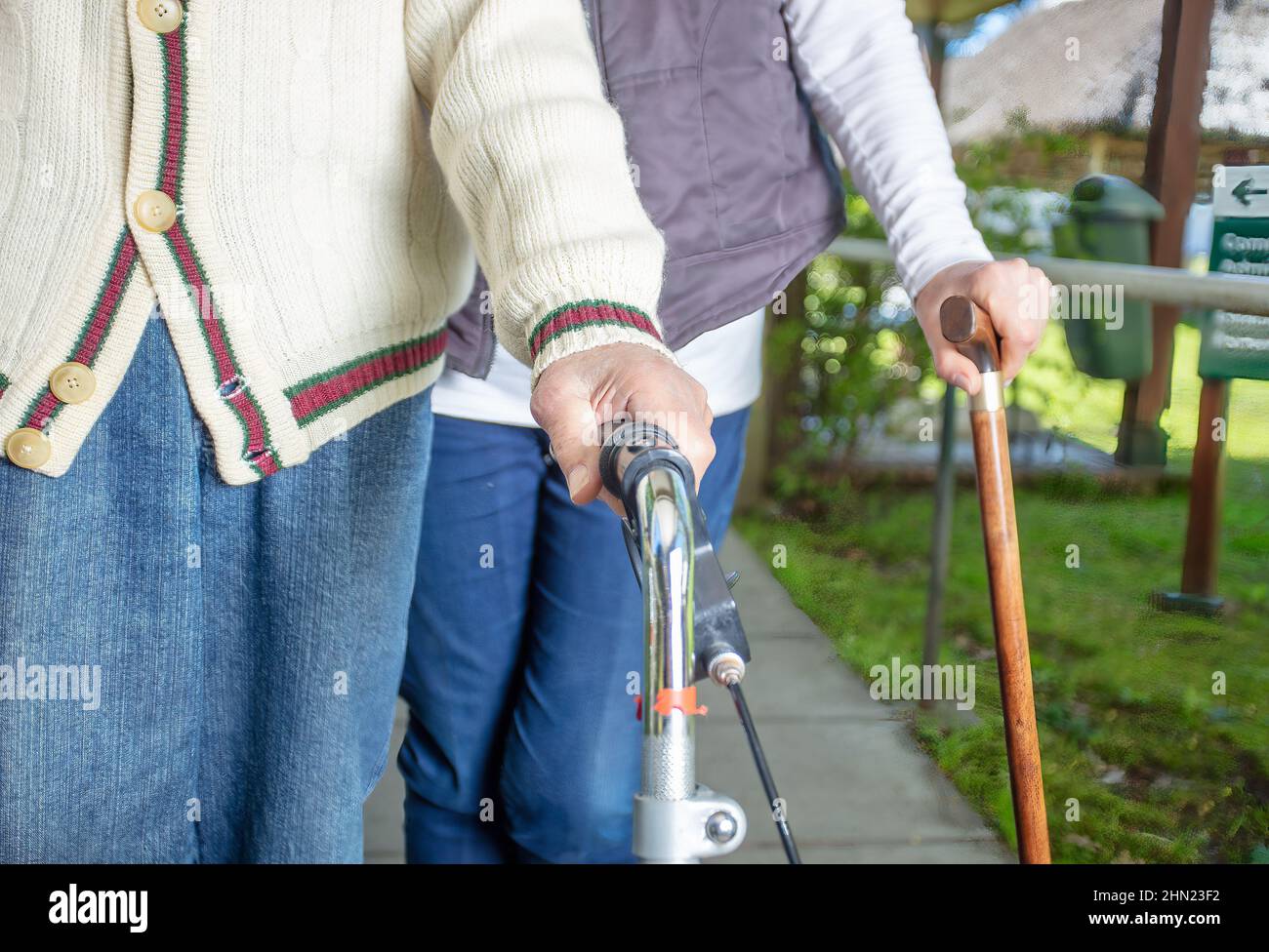 Elderly people with stick and walker outdoor Stock Photo - Alamy