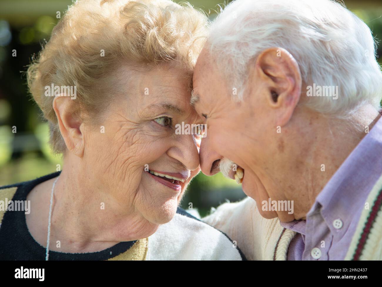 Couple of seniors smiling head to head outdoor. Retired elderly people ...