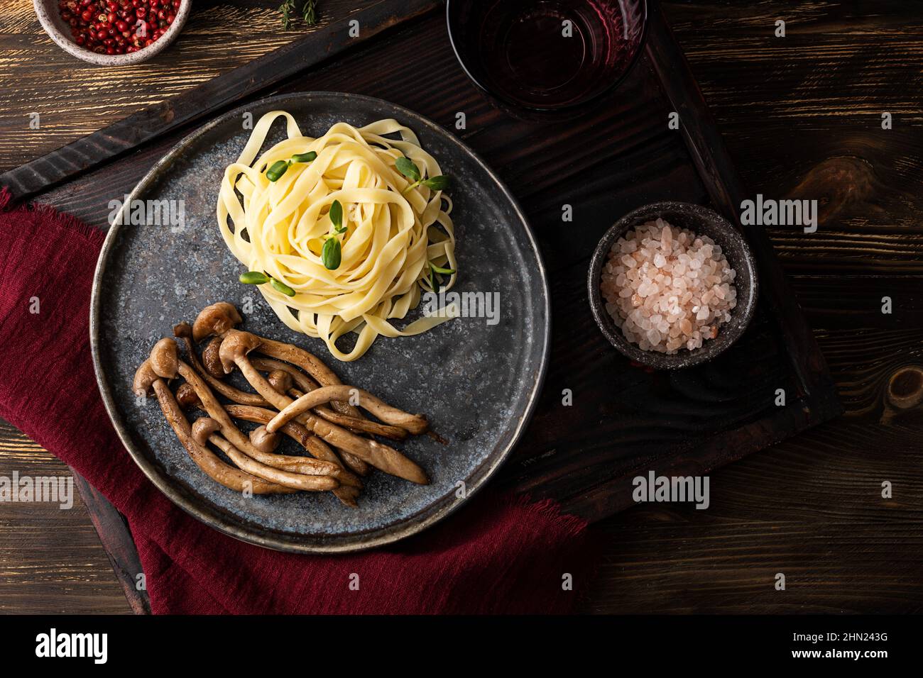 Plate with fried mushrooms and pasta, cooked shimeji and noodles on ...