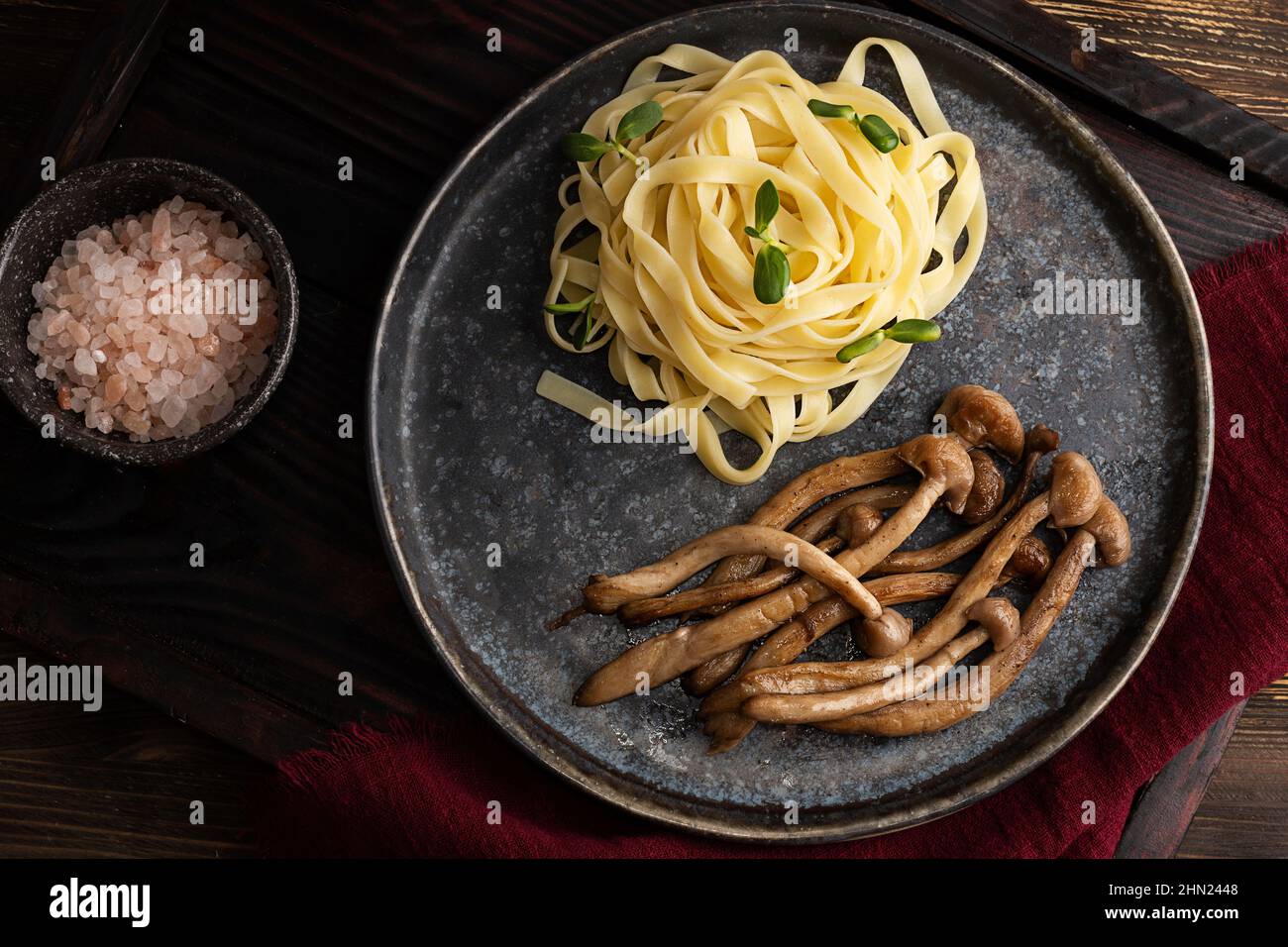 Cooked shimeji and noodles, plate with fried mushrooms and pasta, on ...