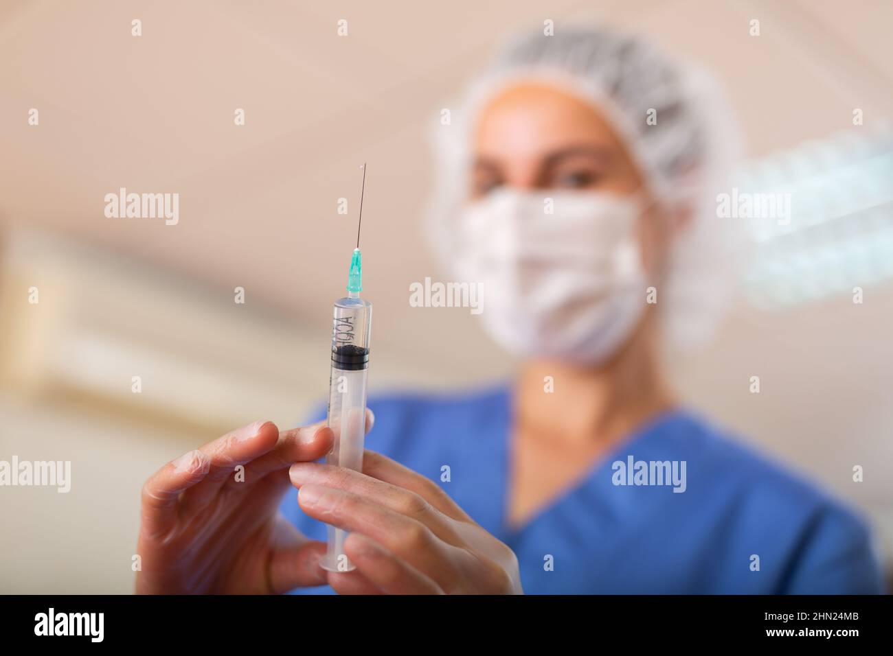 Nurse prepares a syringe for injection Stock Photo - Alamy