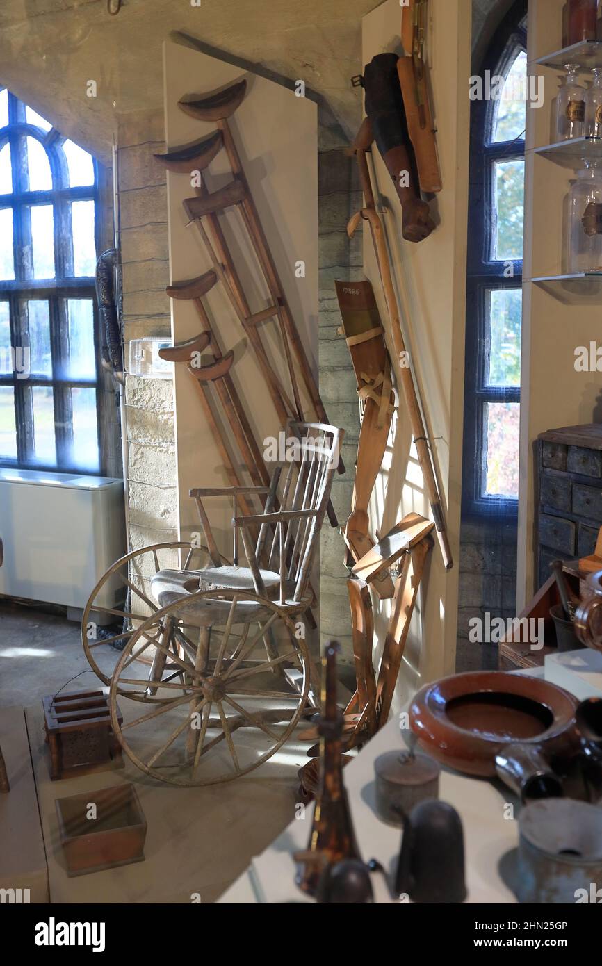 Antique wheelchair and crutches in medical instruments collection ...