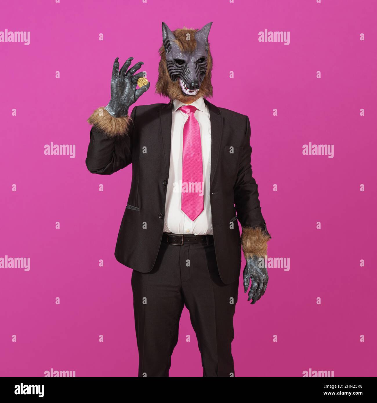 Against a pink background is a man dressed in a black suit with a ...