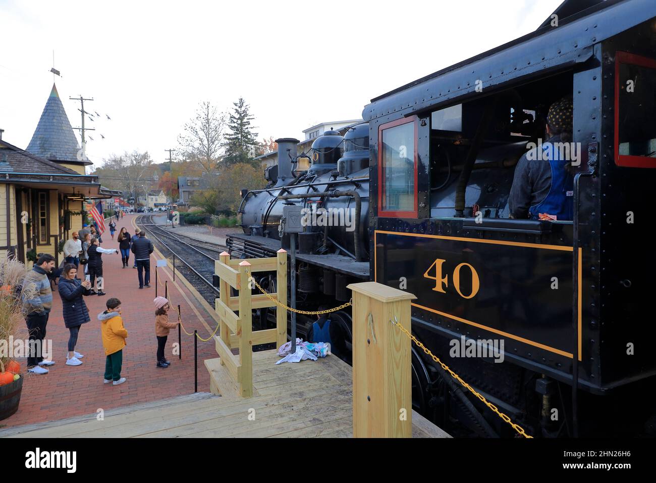 Passengers and visitors admiring the antique steam locomotive at New ...