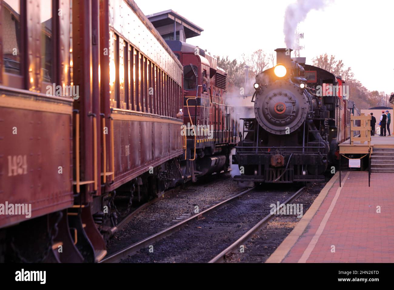 A excursion train passing by an antique steam locomotive at New Hope ...
