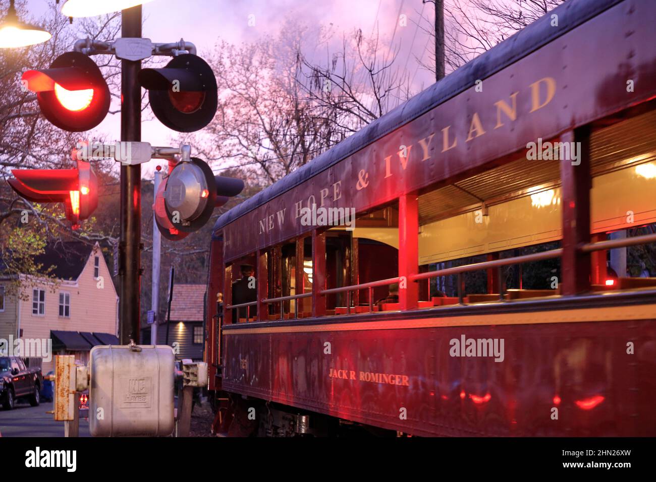 Excursion train passing the signal lights at railroad crossing of New ...