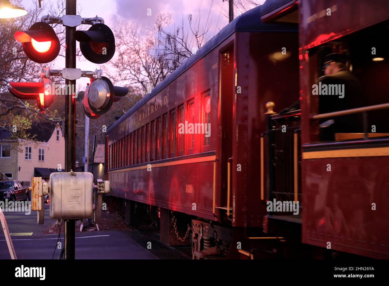 Excursion train passing the signal lights at railroad crossing of New ...
