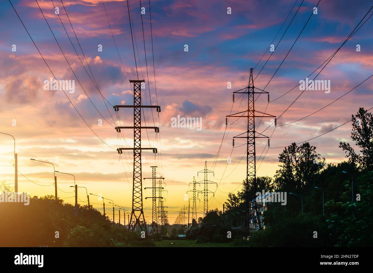 Power lines, sunset evening sky and perspective street in the city ...