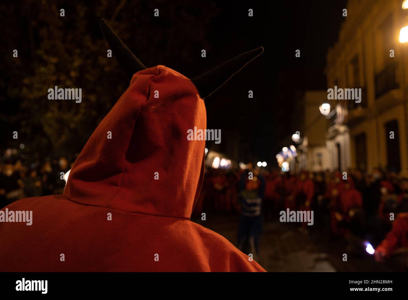Back view of a man dressed as a demon in a fire show at spanish ...