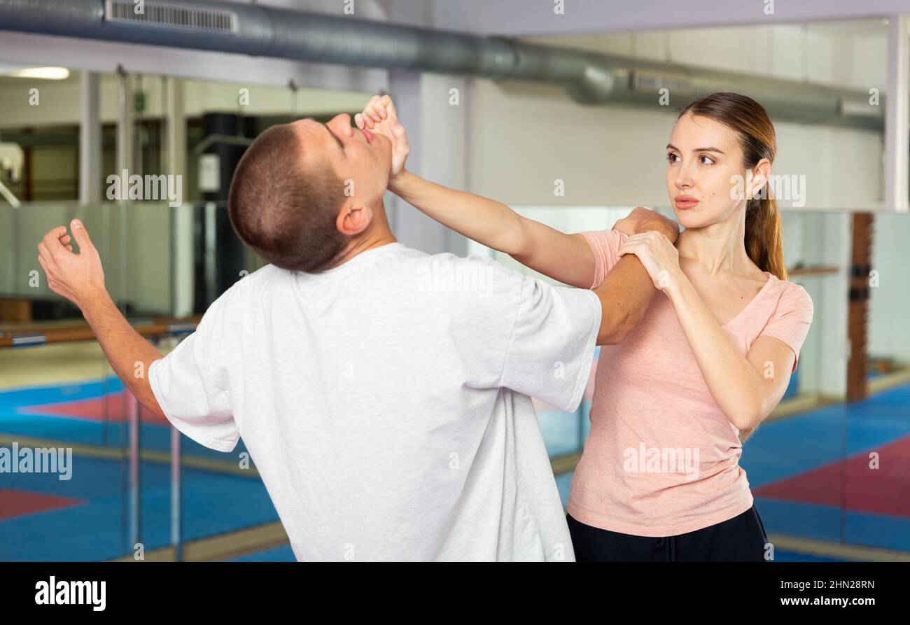 Active girl conducts painful grip on self-defense training in gym Stock ...
