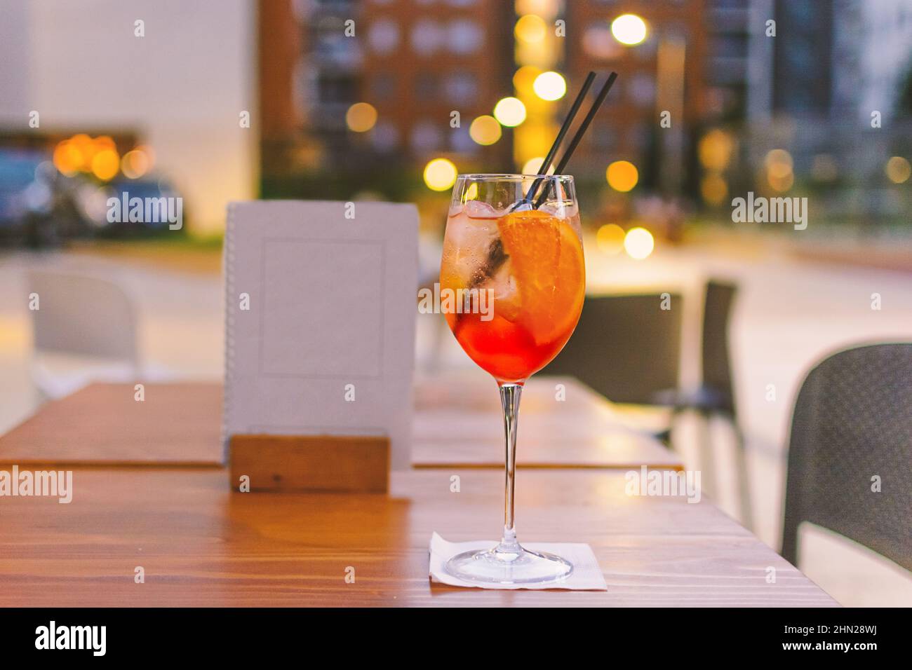 Glass of Aperol Spritz cocktail on the table in a terrace of restaurant ...